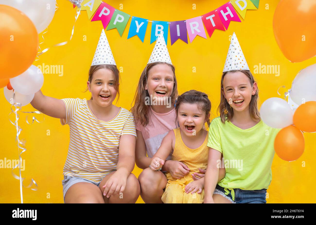 Four girls with balls on a yellow background. Kids at the party Stock ...