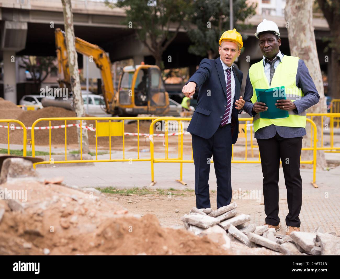 Engineers talking about road repairing outdoors Stock Photo - Alamy