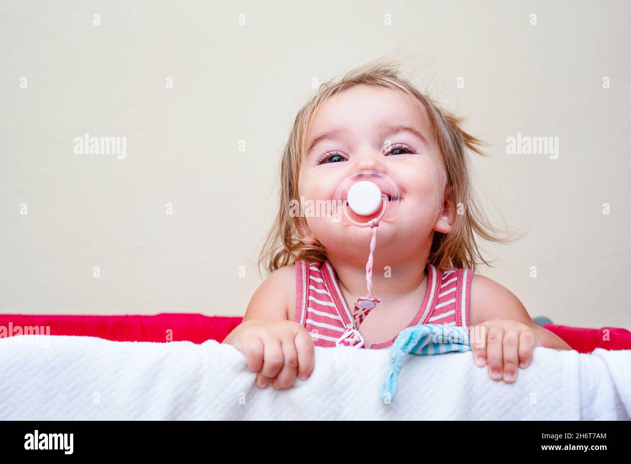 Happy baby jumping in the crib Stock Photo - Alamy