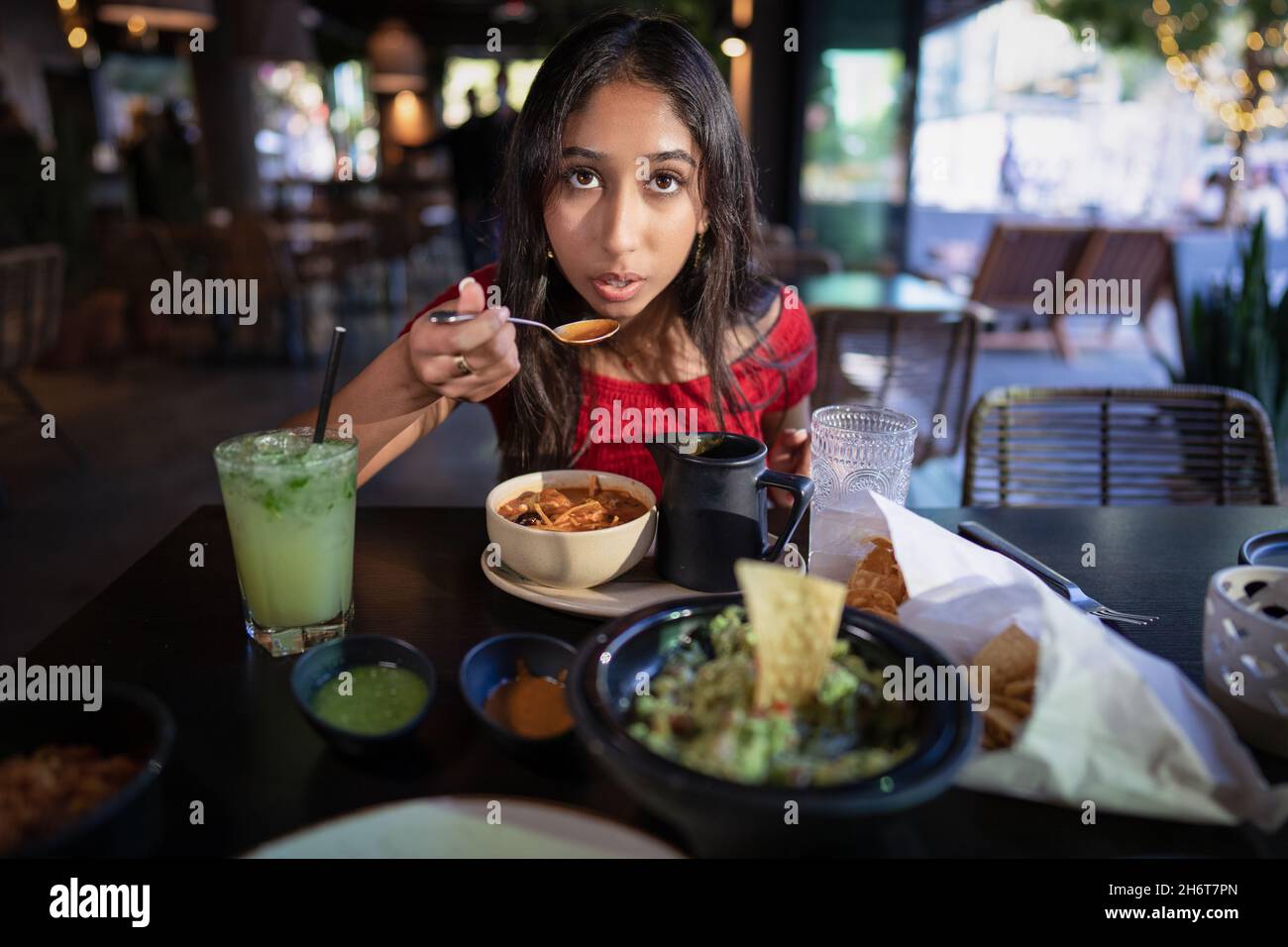 Young Asian Woman Eating Tortilla Soup at a Mexican Restaurant Stock ...