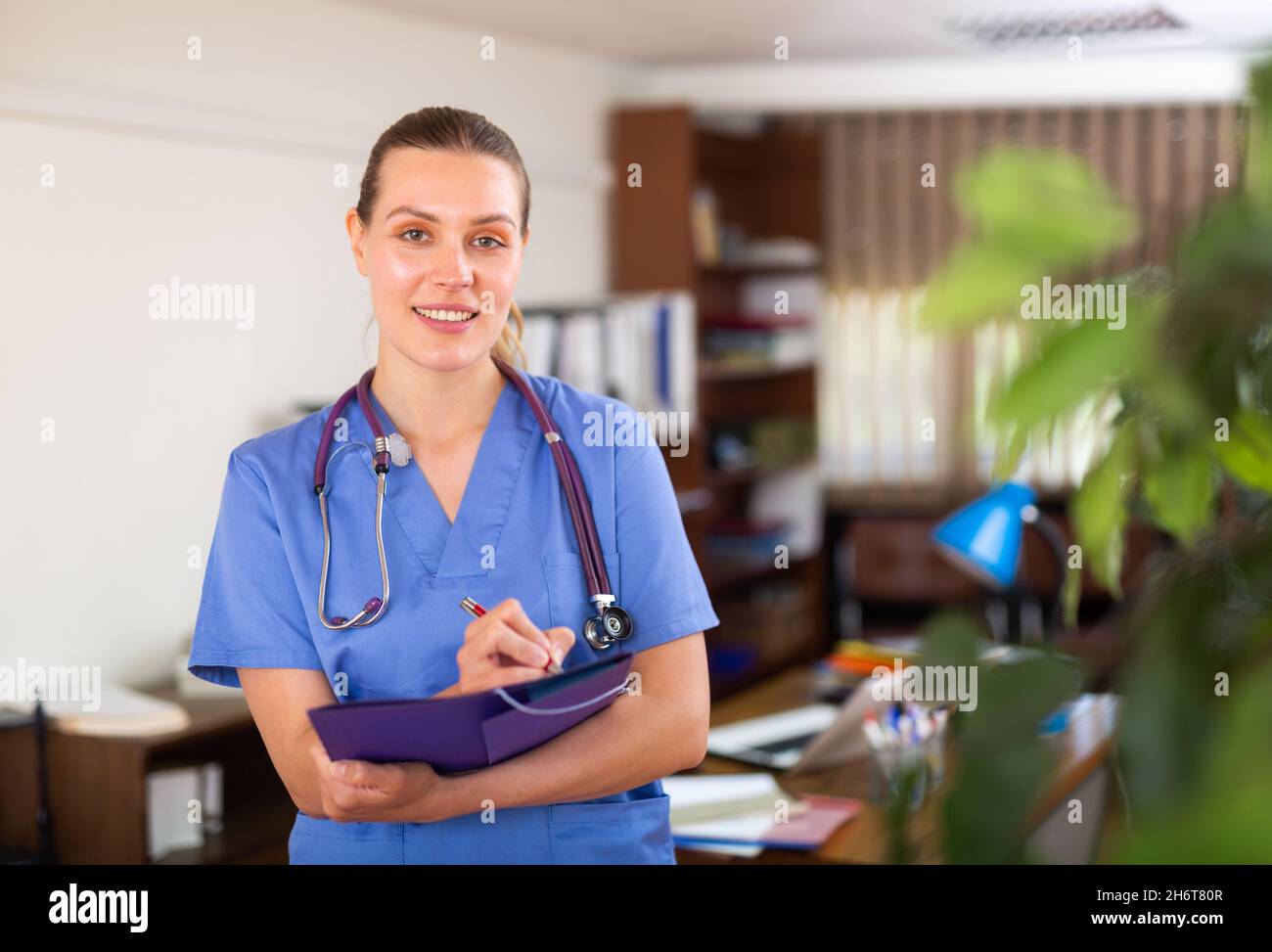 Woman doctor wear white medical uniform and stethoscope with folder of ...