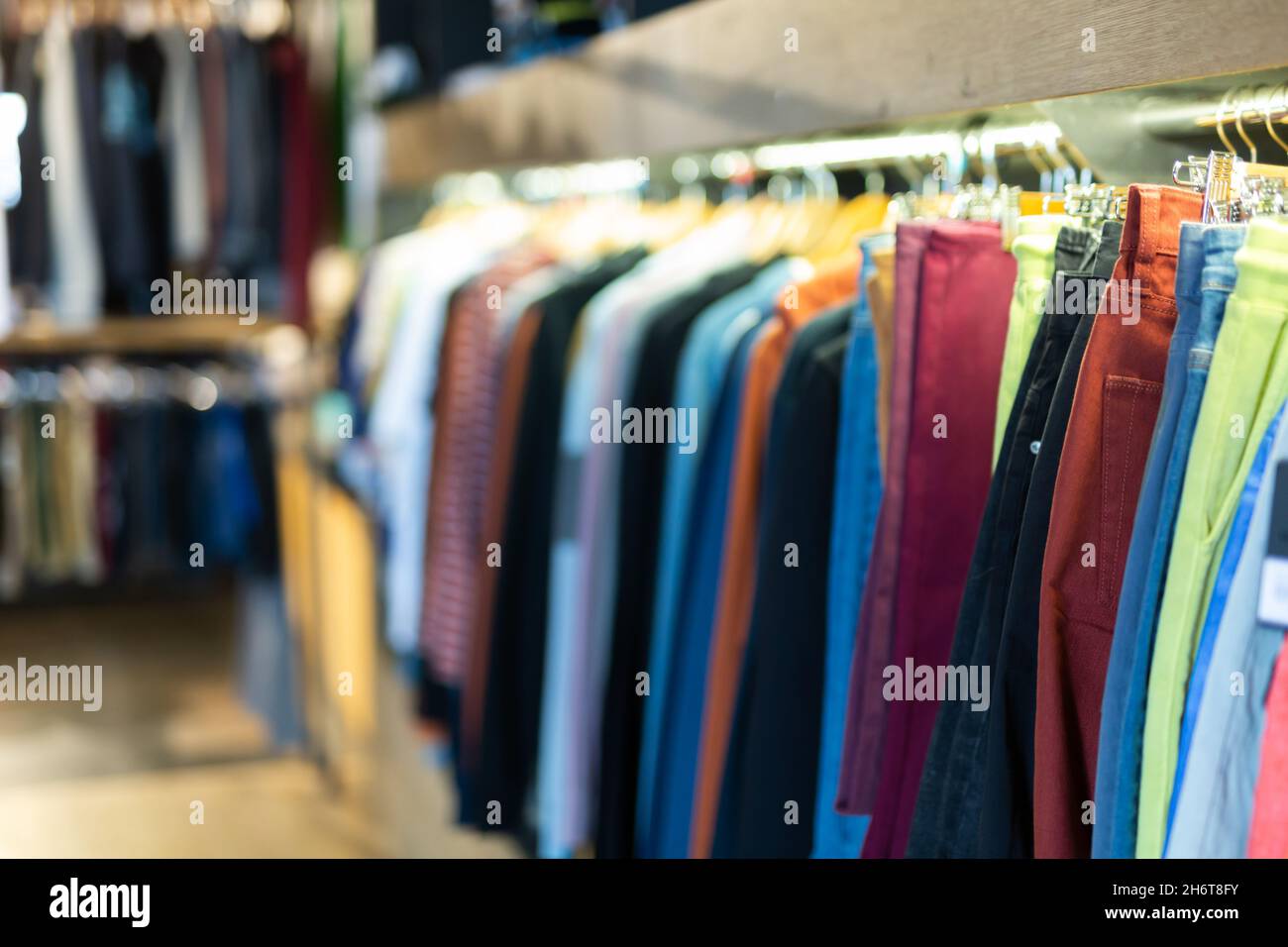 Assortment of summer clothing in modern store Stock Photo - Alamy
