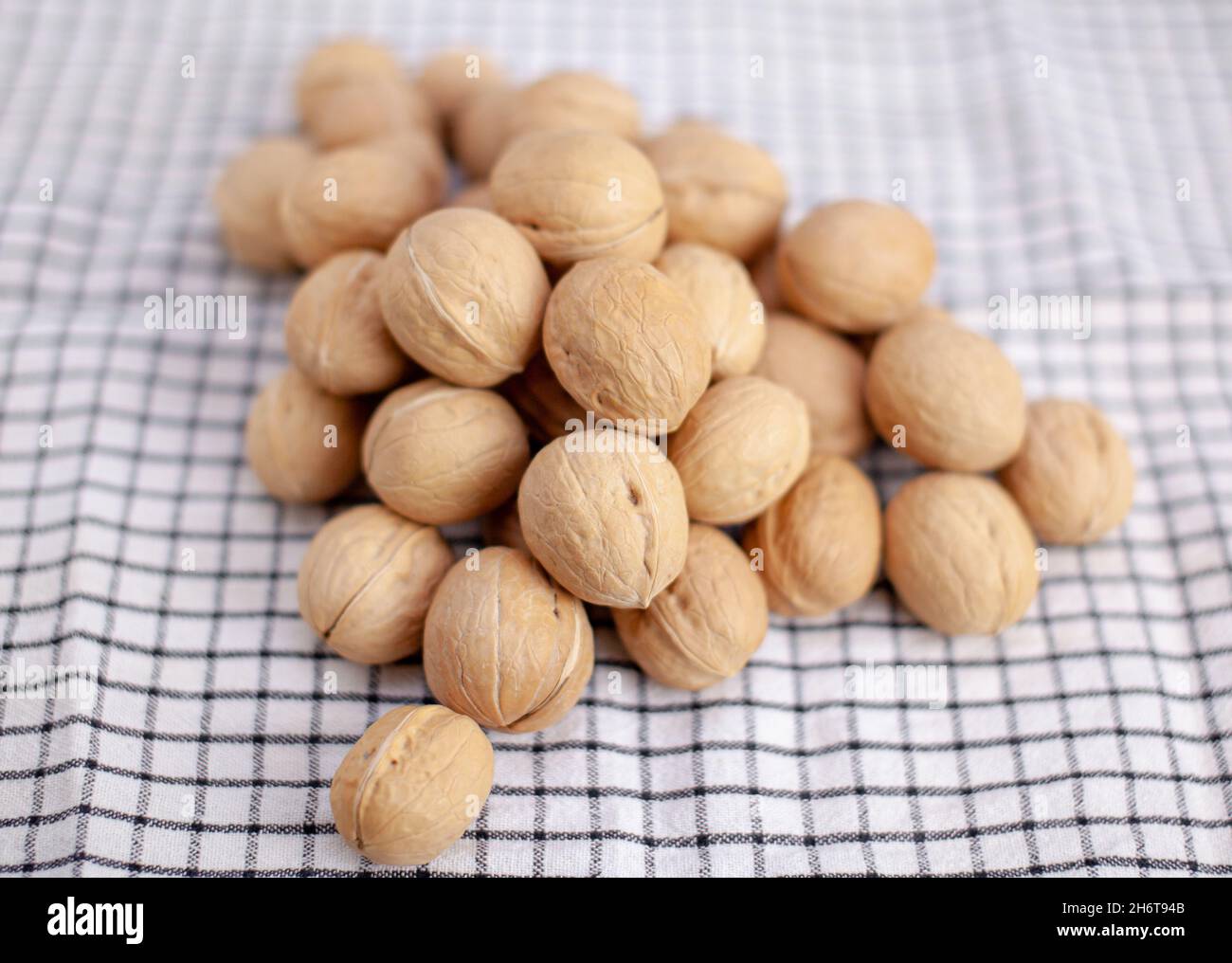 A lot of whole walnuts on a napkin close-up. Healthy, organic and ...