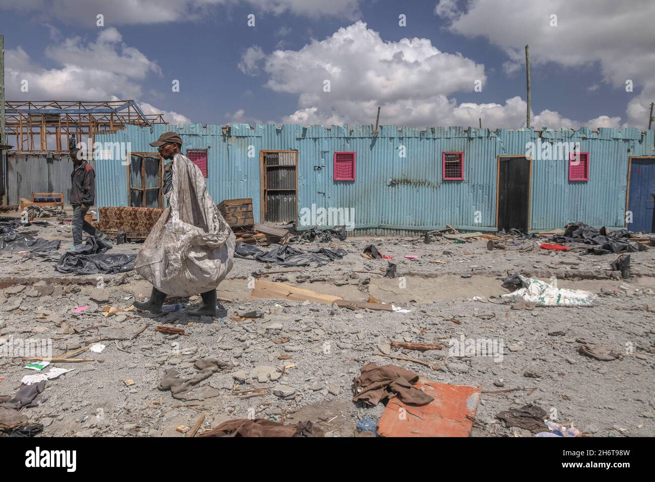 Nairobi, Kenya. 17th Nov, 2021. Residents walk past demolished housing ...