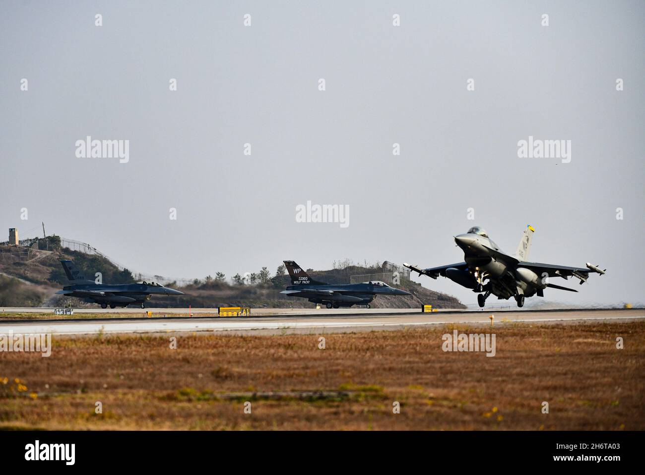 An 80th Fighter Squadron F-16 Fighting Falcon lands on the runway past ...