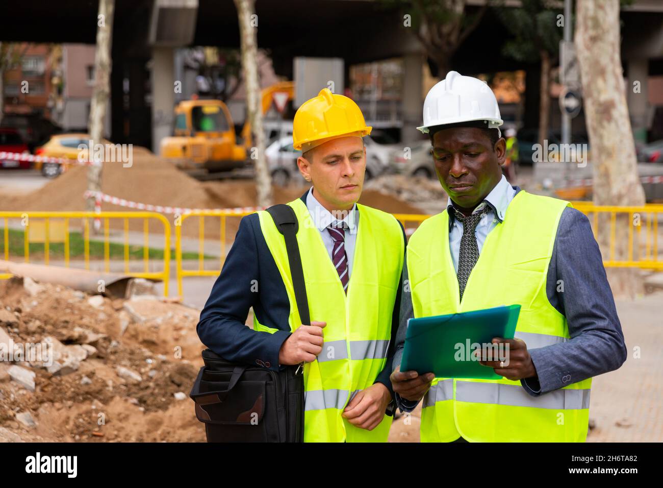 Two workers are studying a folder with important working papers Stock ...