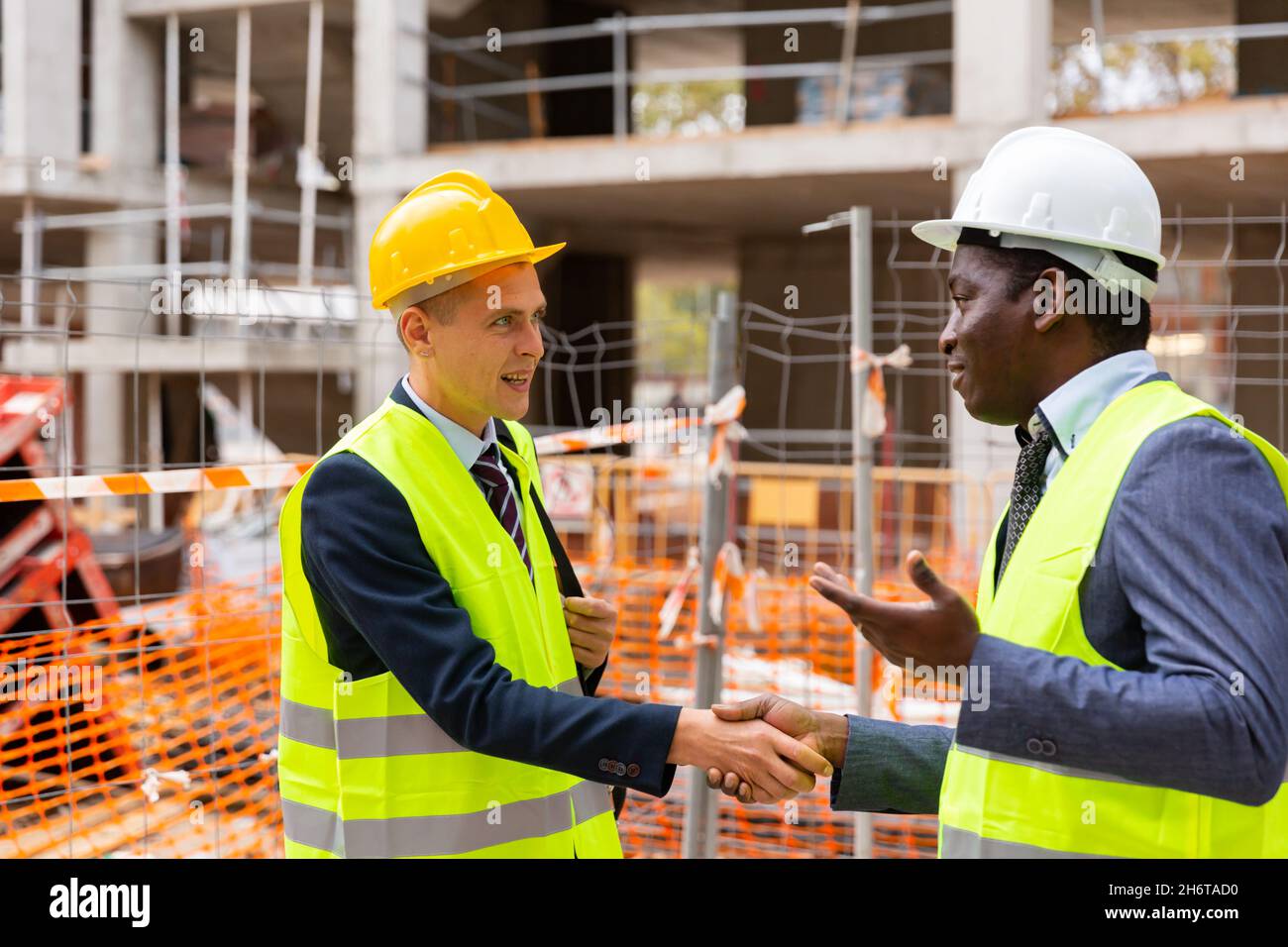 Engineers shaking hands on construction site Stock Photo - Alamy