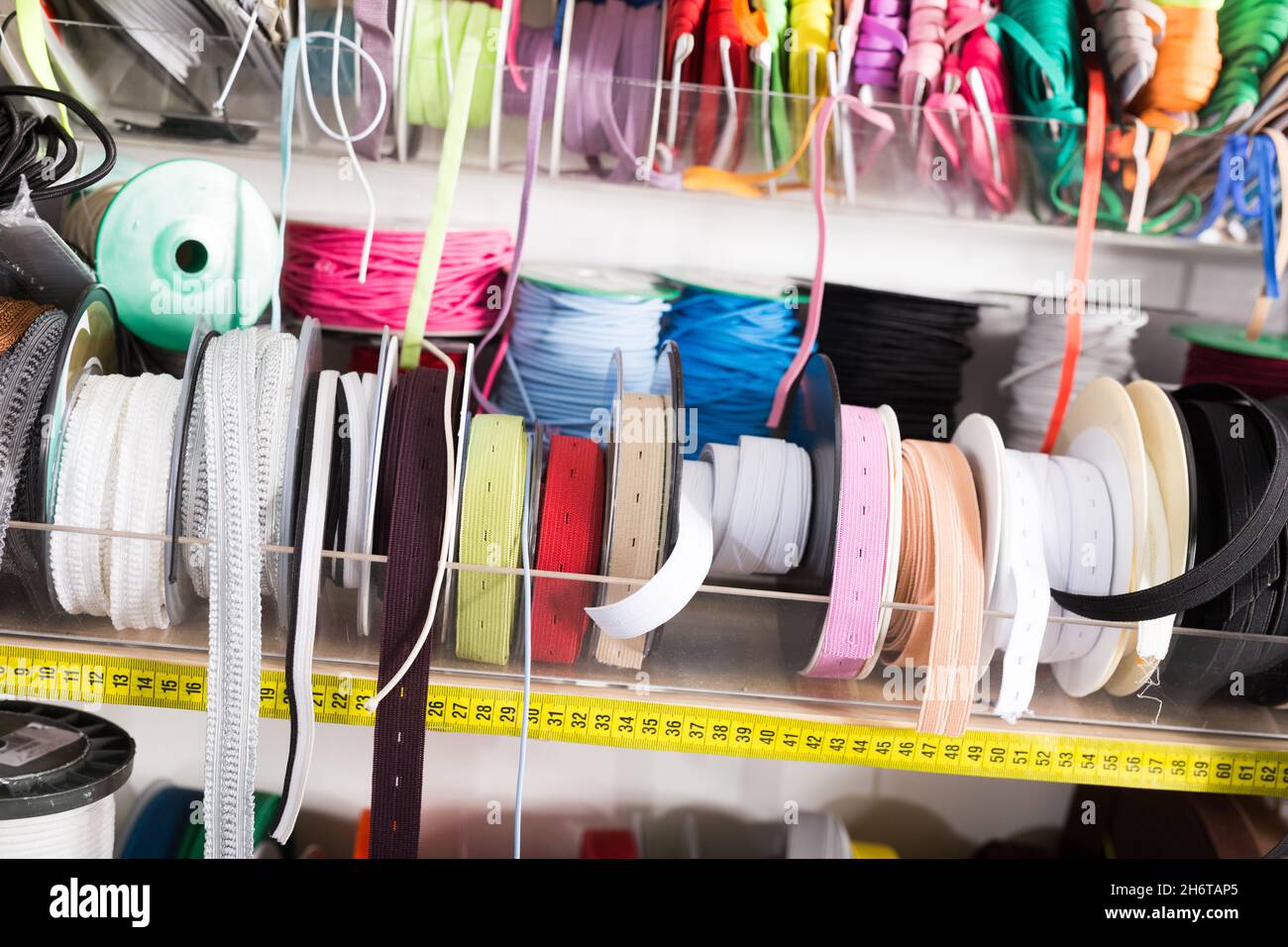 Colored ribbons on needlework store shelves Stock Photo - Alamy