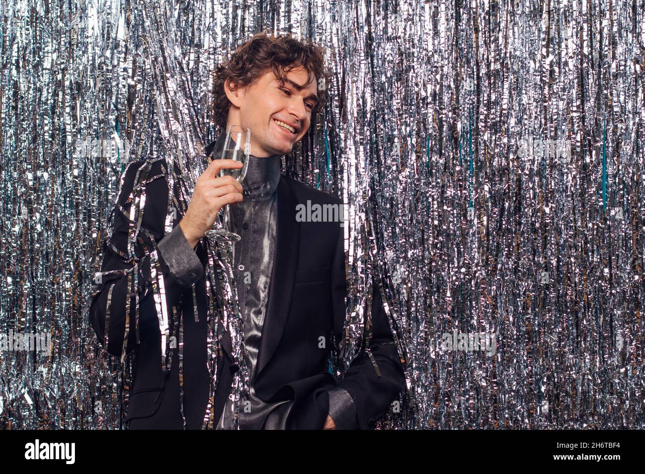 Happy tipsy man with bottle of champagne and wine glass at christmas or ...