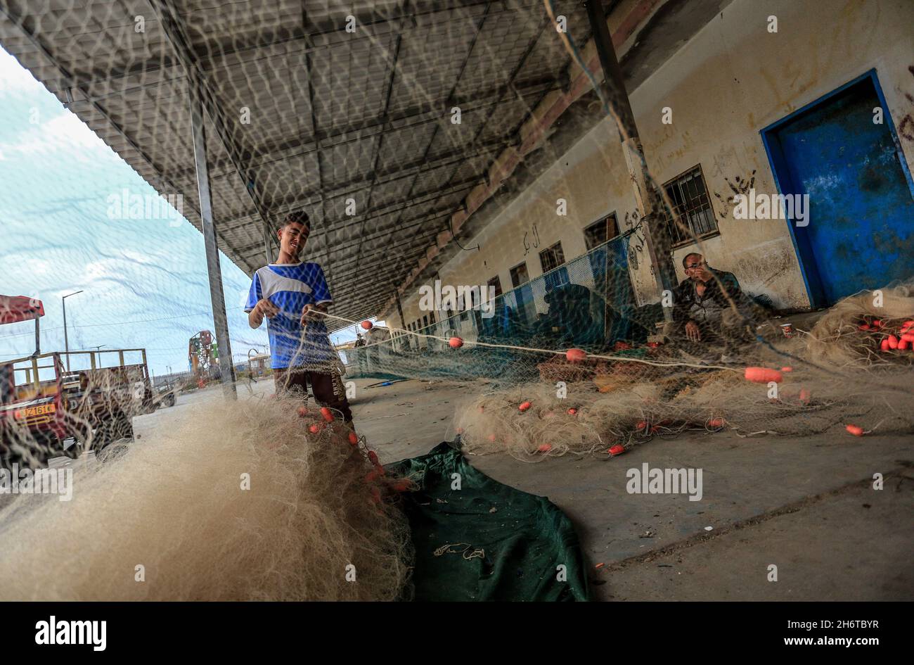 Gaza City, Palestine. 16th Nov, 2021. A Palestinian sewing a fishing ...