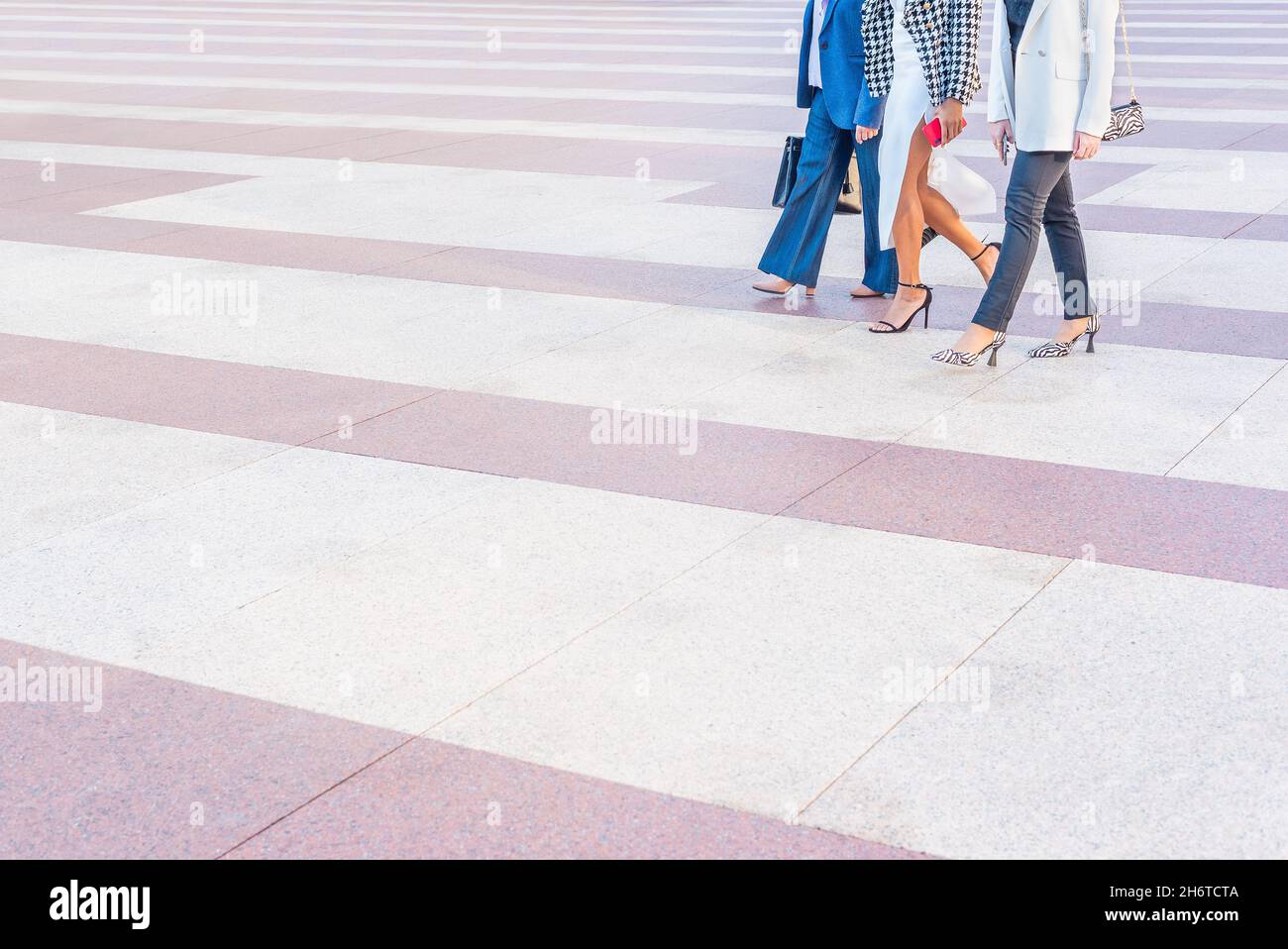 three business women walking across a pedestrian crossing Stock Photo ...