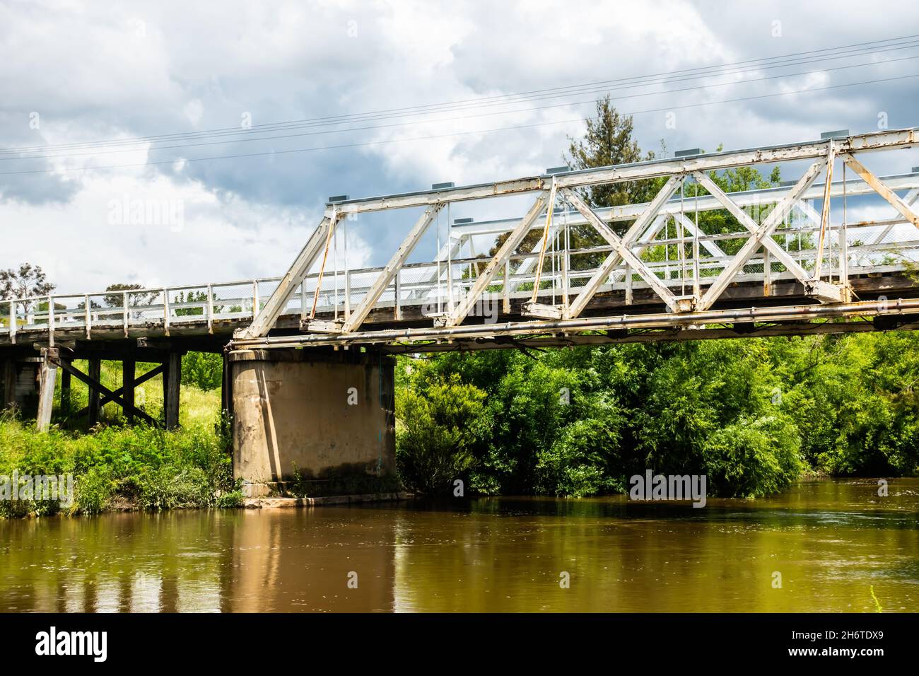 The swollen Macdonald River flowing under the closed bridge at ...