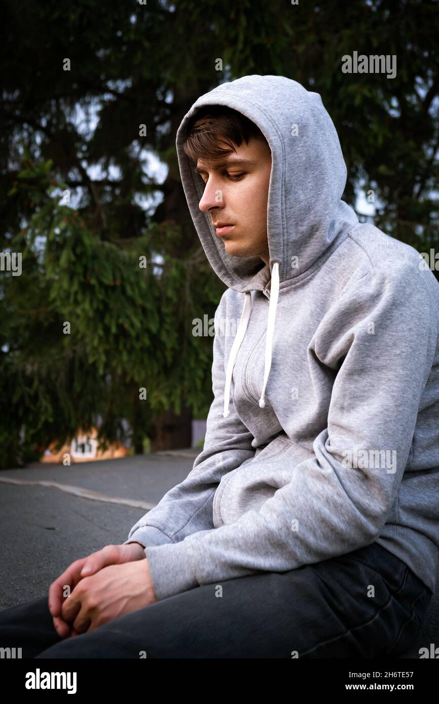 Sad Young Man Portrait in a Hoodie on the Nature Background Stock Photo ...
