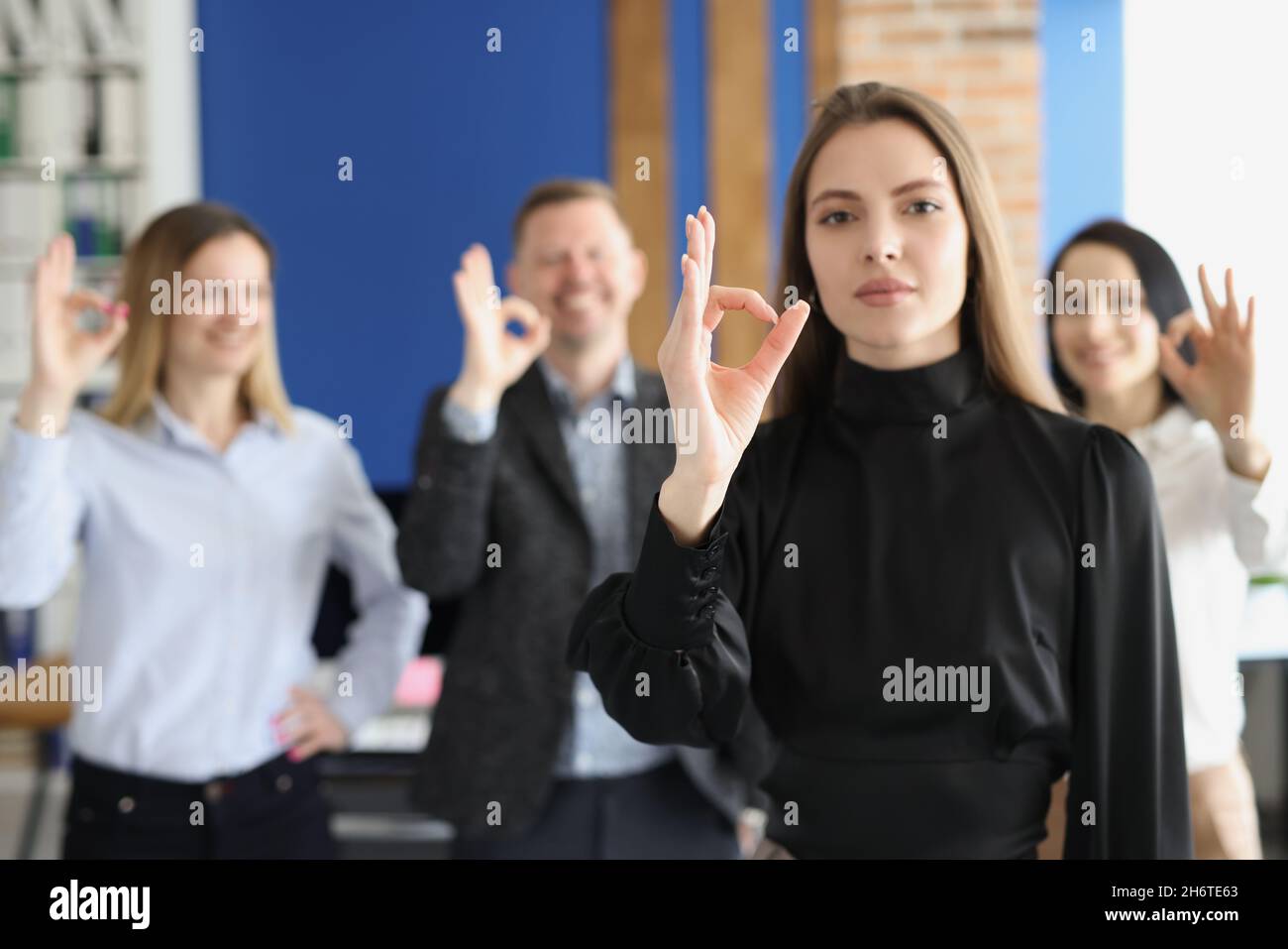 Coworkers showing ok gesture with hands good teamwork and successful ...
