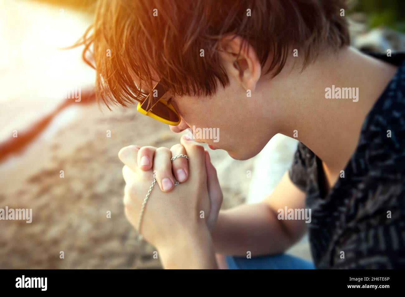 Young Man Praying on the Nature Background closeup Stock Photo - Alamy