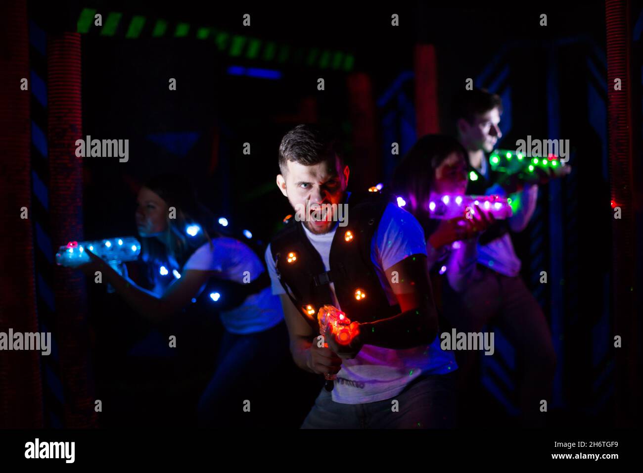 Emotional guy playing laser tag Stock Photo - Alamy