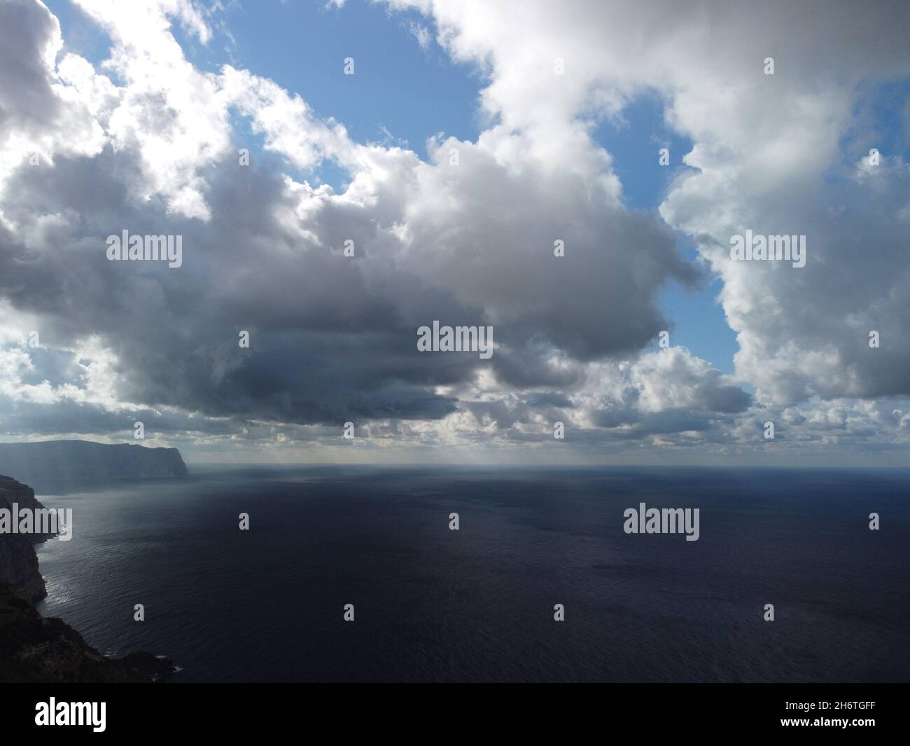 Abstract airy sky with moving plump clouds over the sea ocean. Small ...