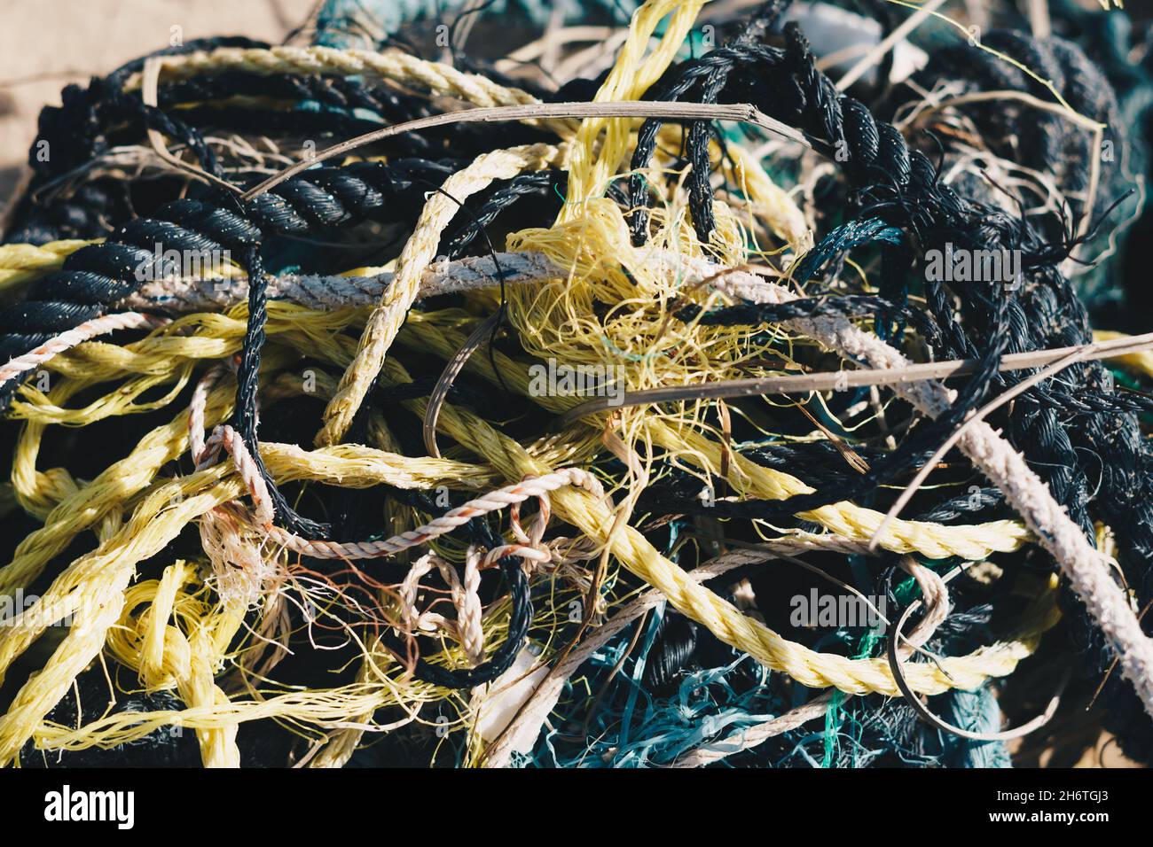 E Close multi colored black white yellow green old fishing twisted ...