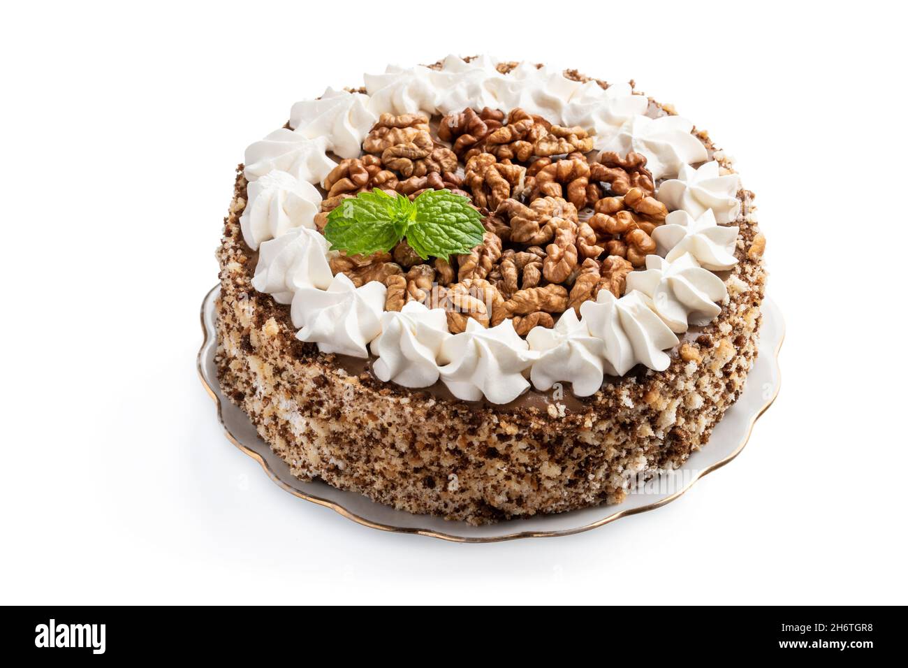 decorated sponge cake with mint leaves with walnuts isolated on white ...