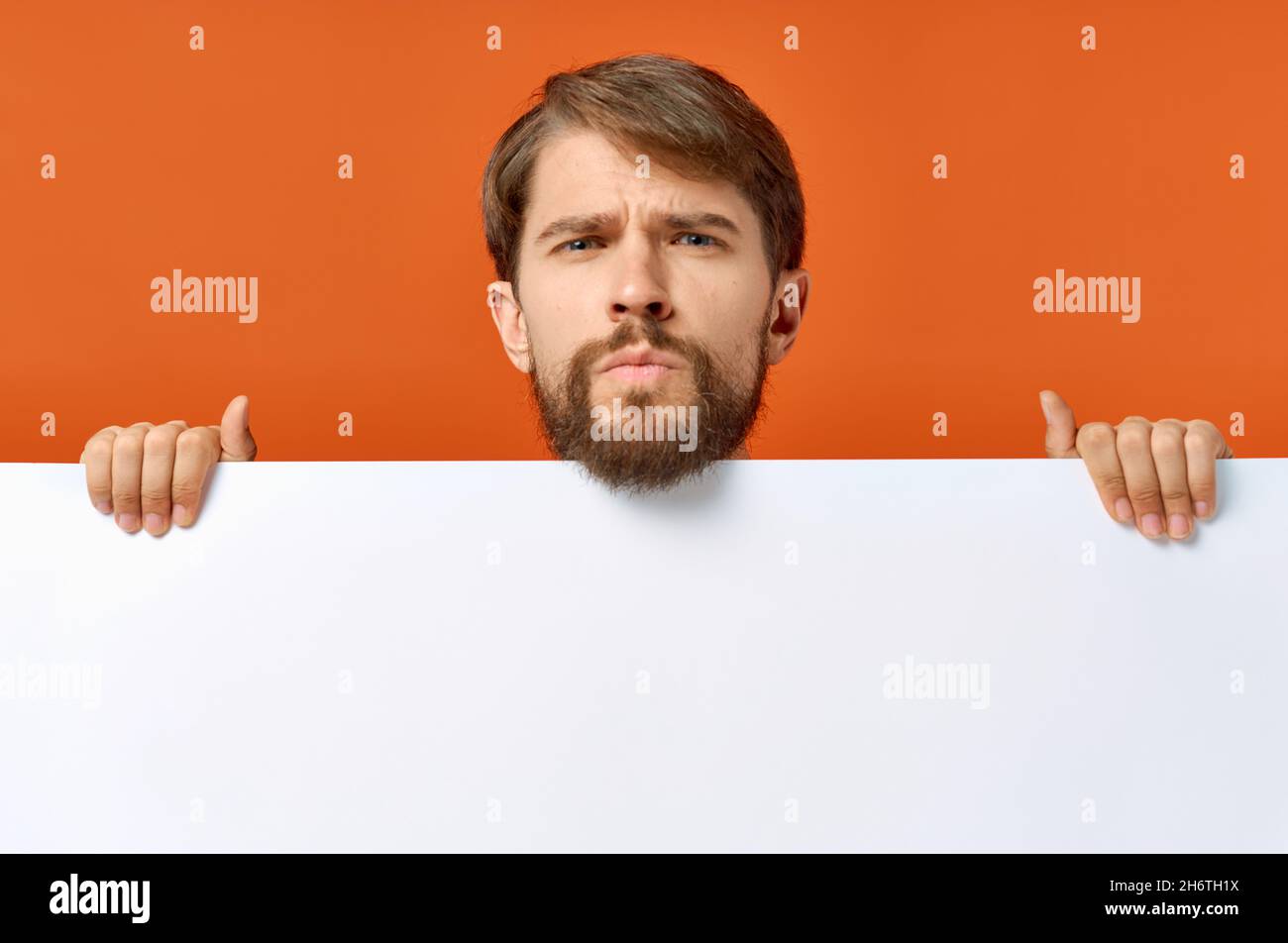 emotional man holding a white banner design orange background Stock ...