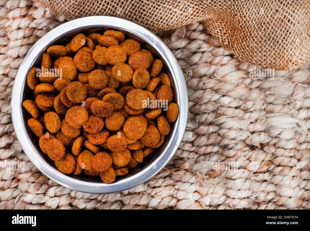 bowl of dry dogfood kibbles with rustic background Stock Photo - Alamy