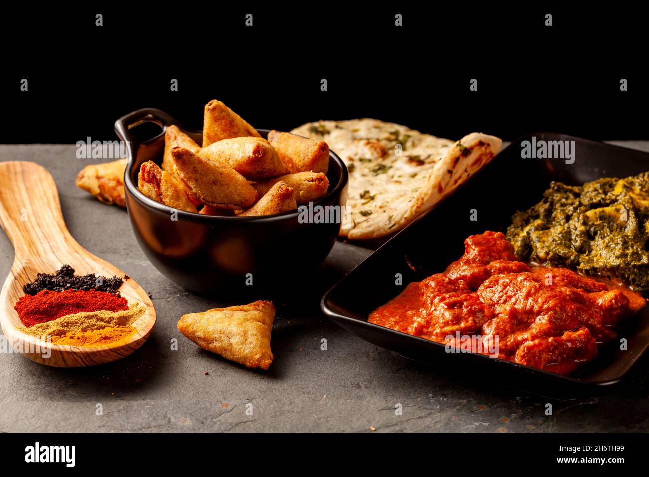 Close up image of a table with delicious dishes from India. Low light ...