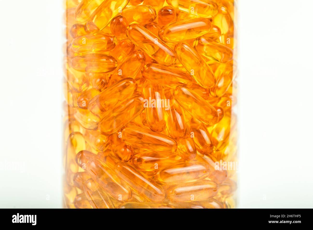 Fish oil in gelatin capsules isolate. Omega vitamins in golden colored ...