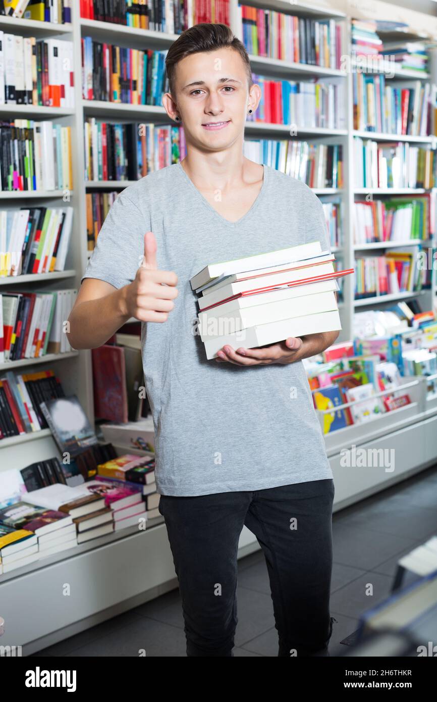 Boy carrying books library hi-res stock photography and images - Alamy