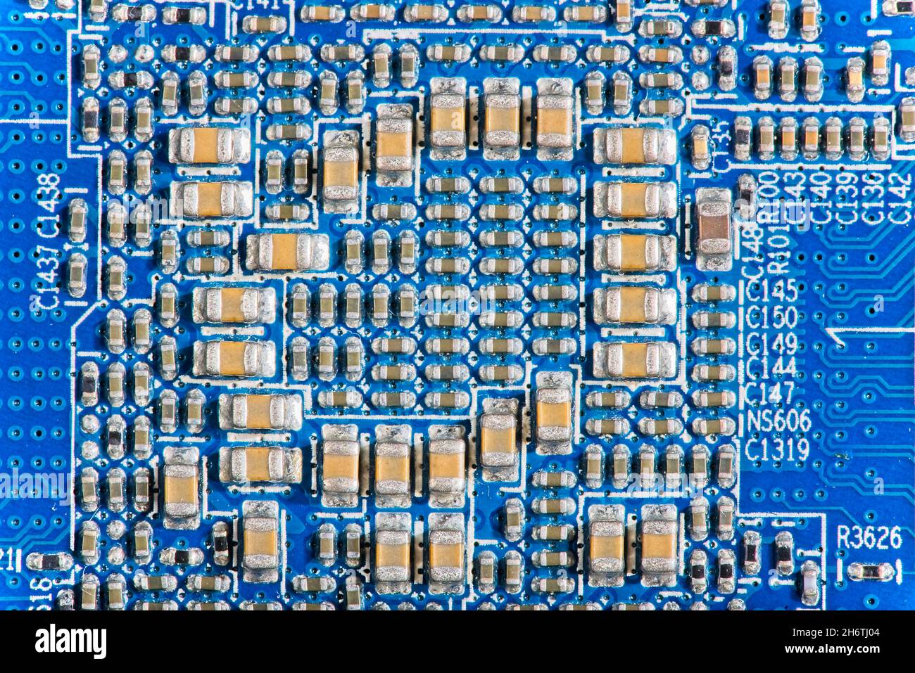 Flat view macro of resistors on blue computer circuit board clustered ...