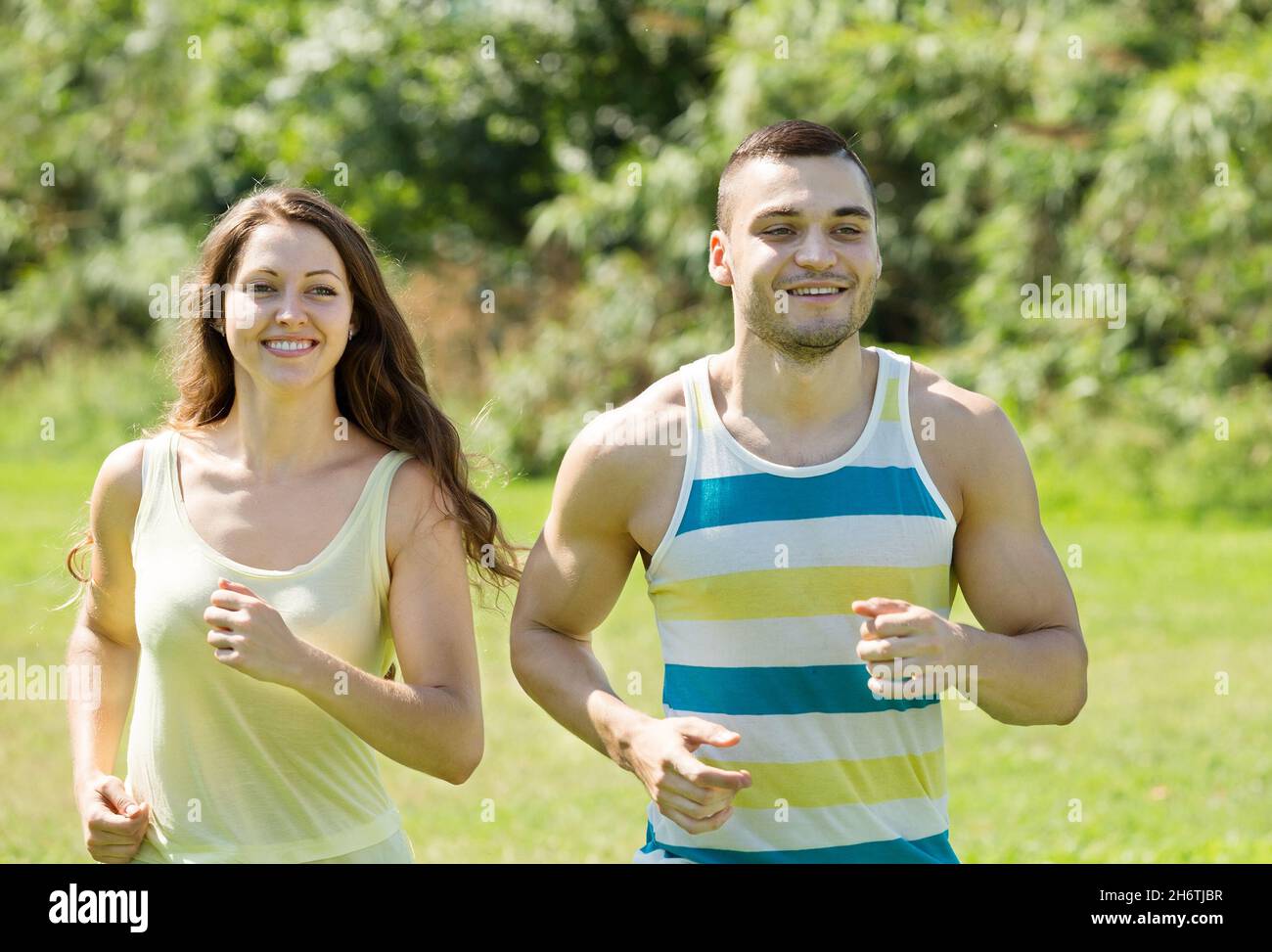 Happy couple running in park Stock Photo - Alamy