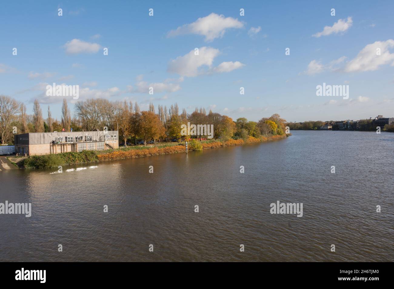 The River Thames meandering past an autumnal Dukes Meadows in Chiswick ...