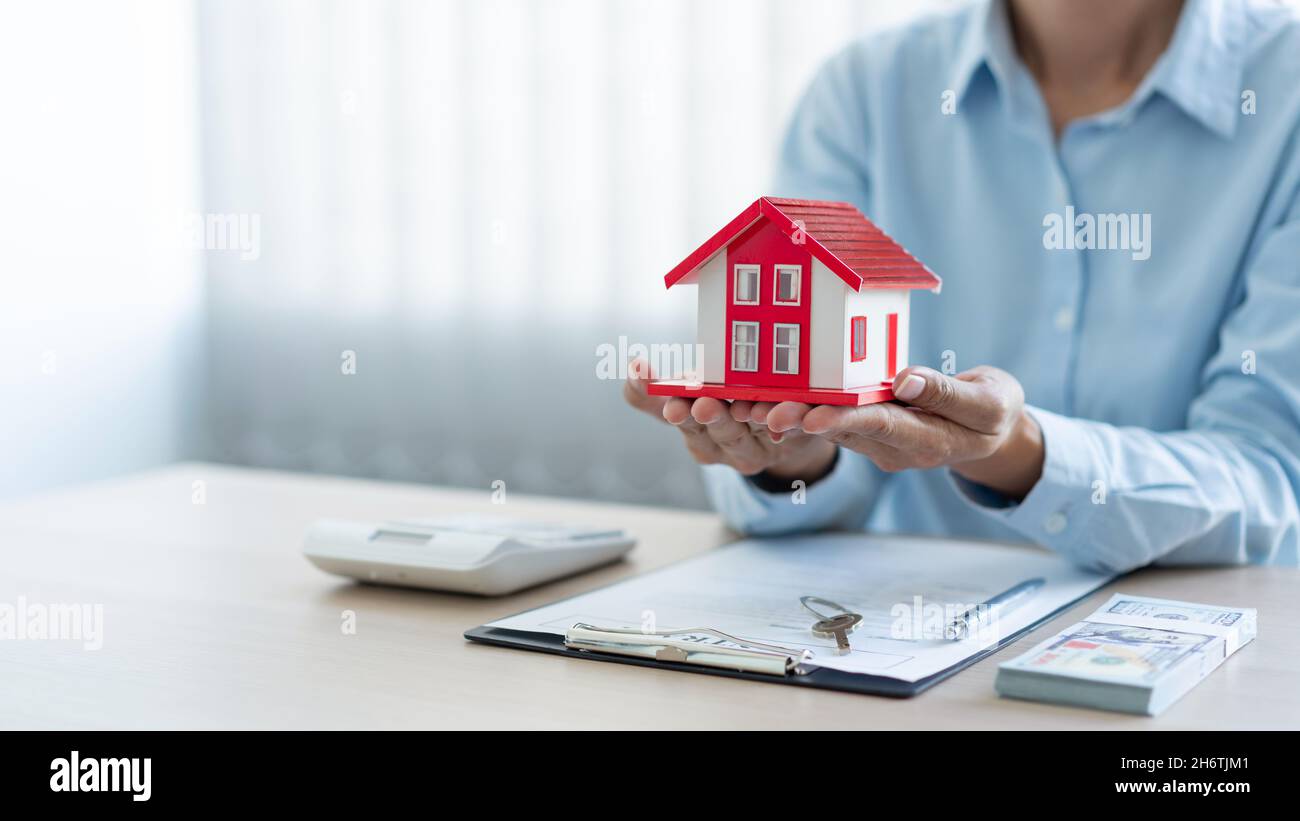 The real estate concept the realtor presenting his work towards his ...