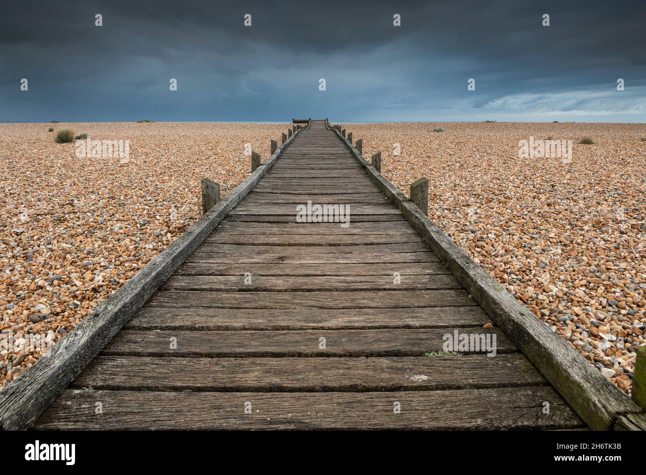 A wooden walkway on a shingle beach at Lydd-on-sea, Kent Stock Photo ...