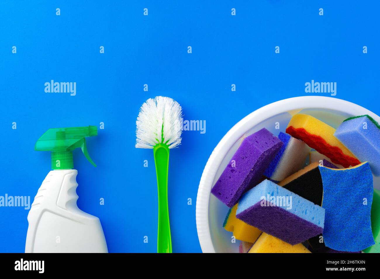 House cleaning supplies on blue color background Stock Photo - Alamy