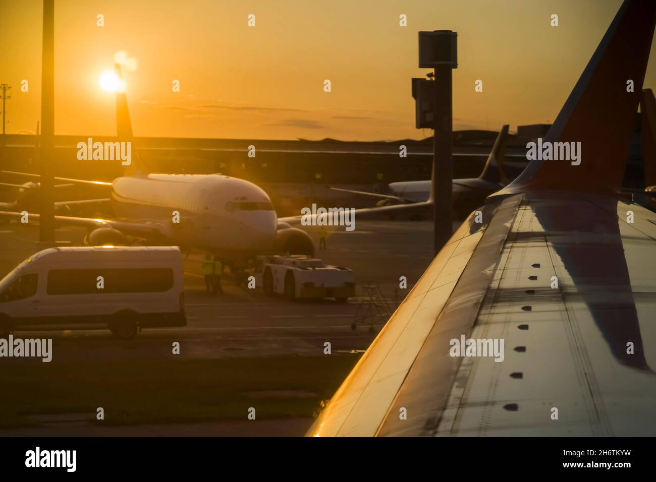 Airplane at sunset on the runway Stock Photo - Alamy
