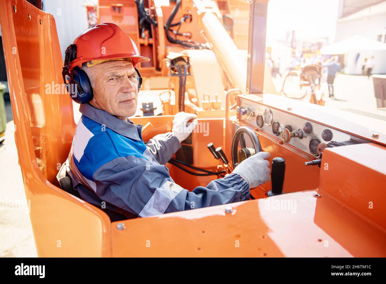 Banner industrial man holding hard hat on background of excavator ...