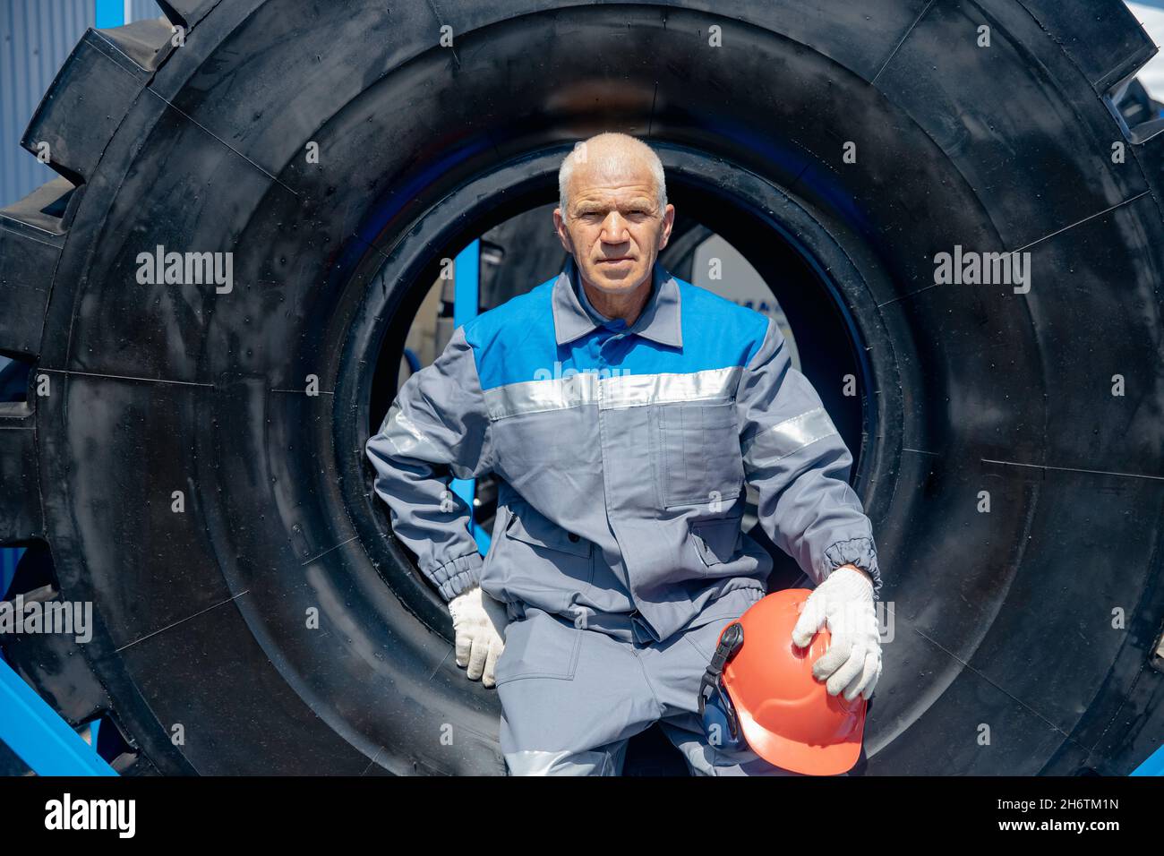 Bulldozer driver coal mine in uniform with helmet and headphones ...