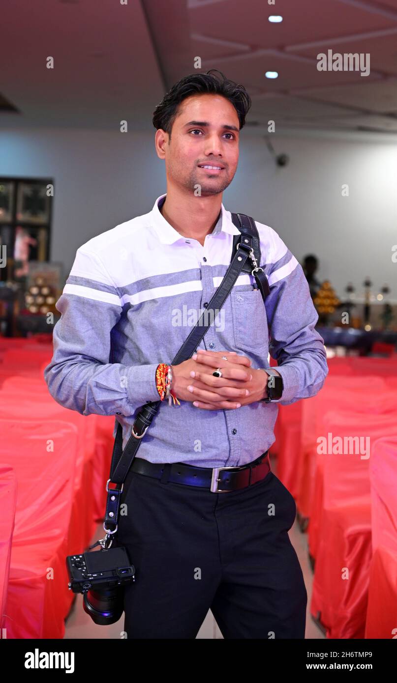 Smiling Indian photographer carrying cameras during an event Stock ...