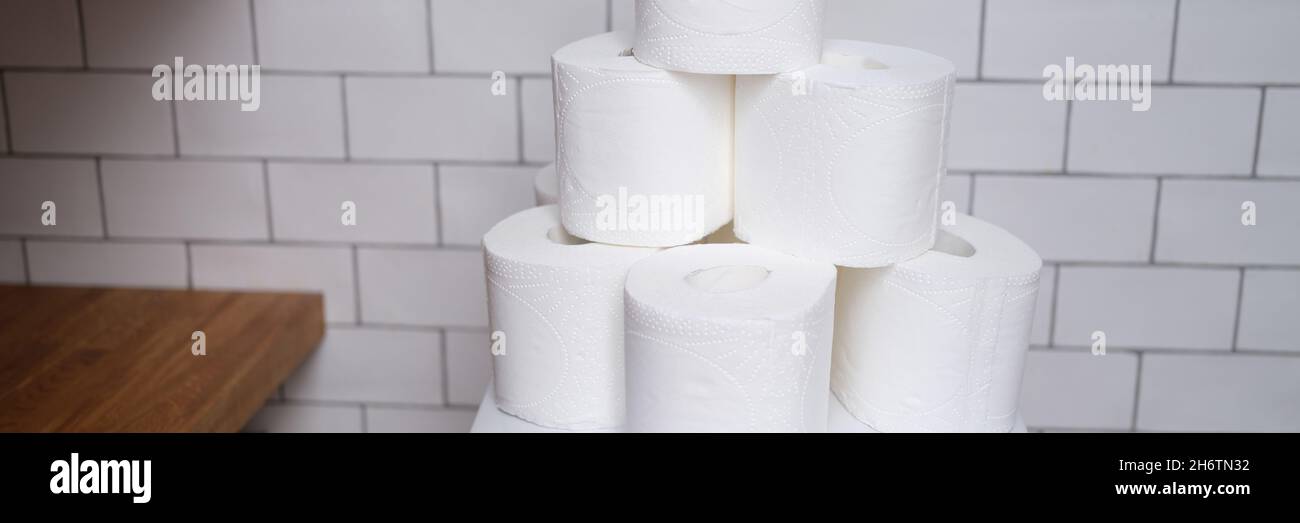 Stack of toilet paper stands on white toilet in bathroom closeup Stock ...