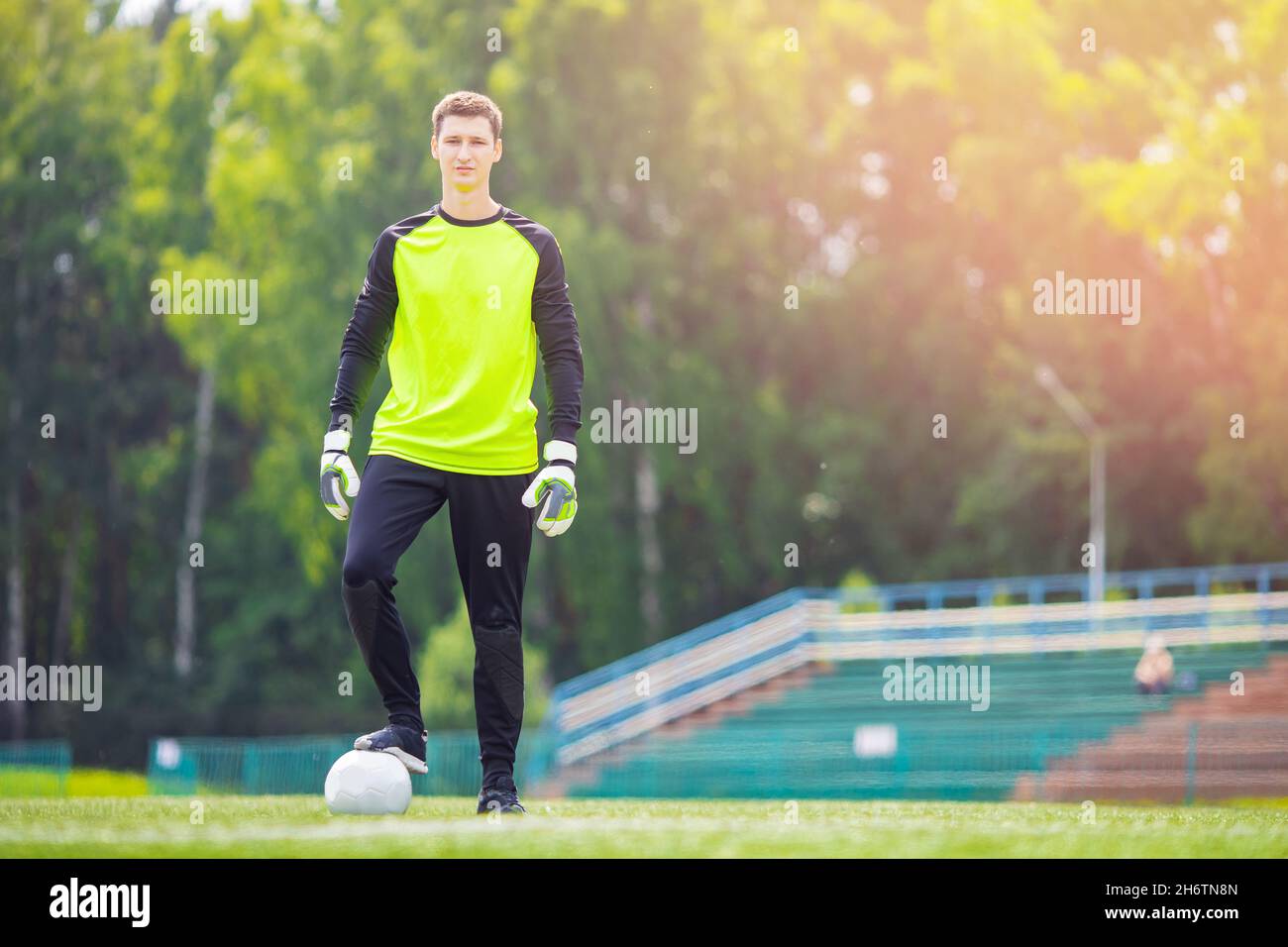 Portrait man goalkeeper with soccer ball in summer stadium, concept ...