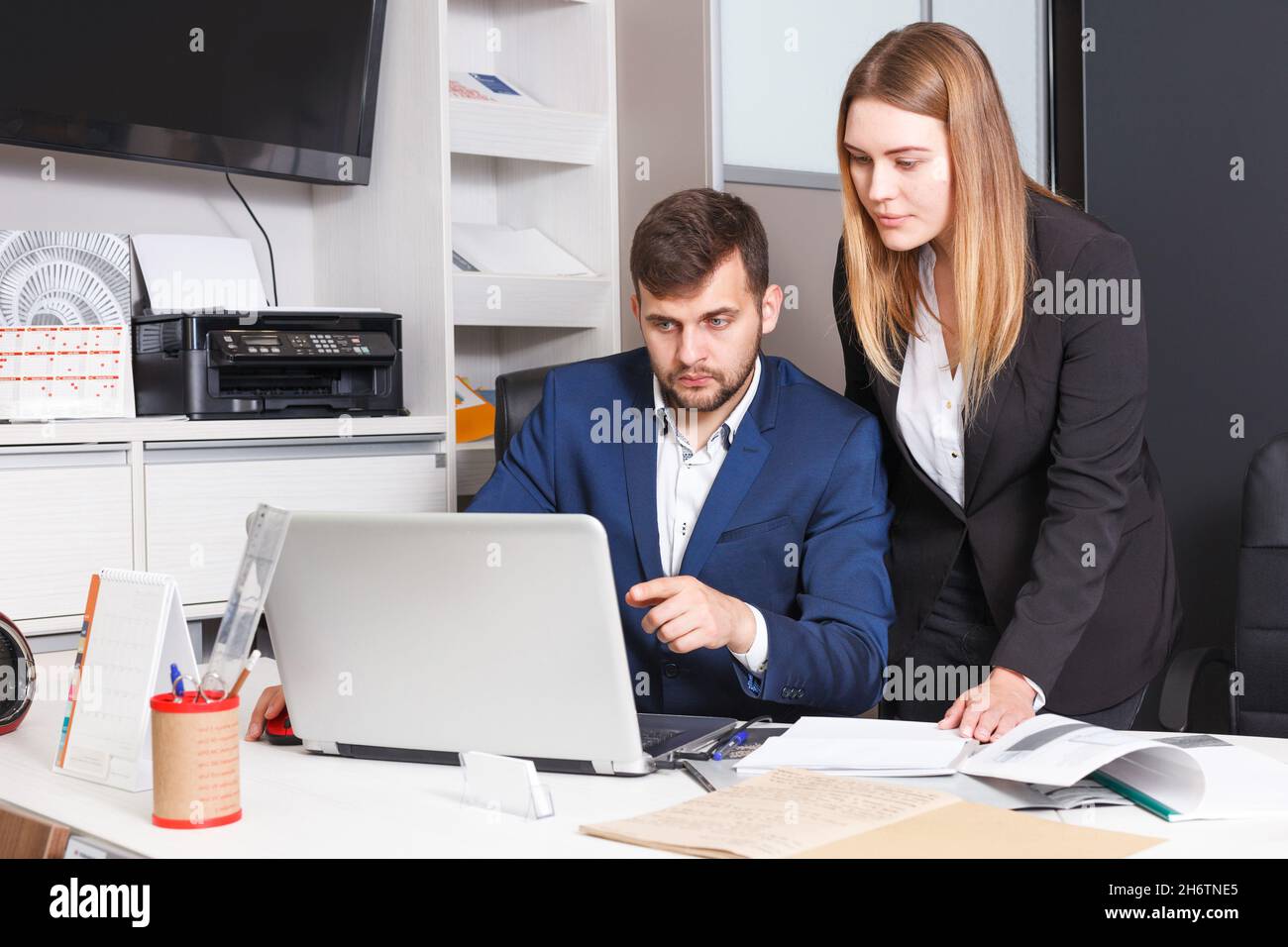 Administrator and seller at workplace in showroom Stock Photo - Alamy