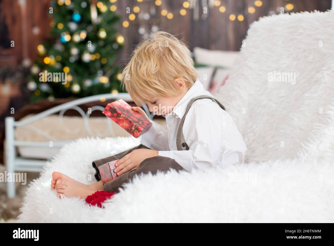 Little boy reading in armchair hi-res stock photography and images - Alamy