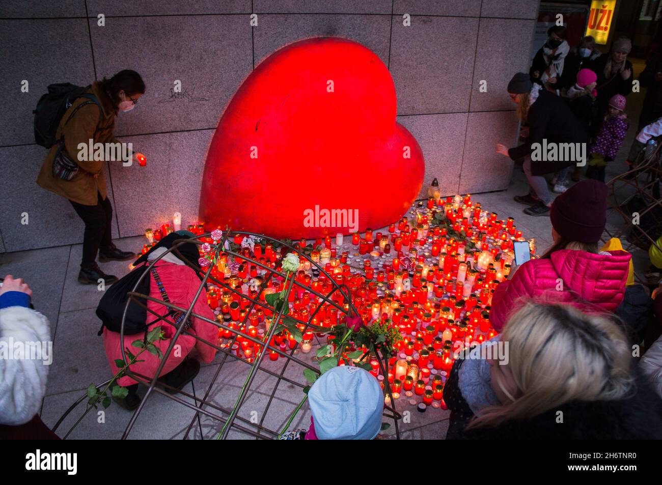 People light candles by the Vaclav Havel memorial by sculptor Kurt ...