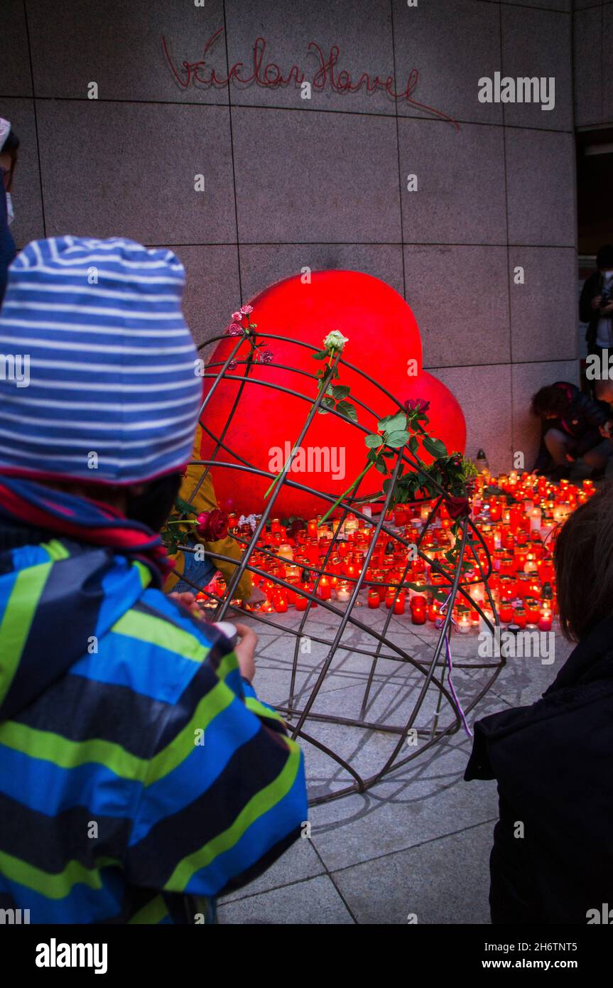 People light candles by the Vaclav Havel memorial by sculptor Kurt ...