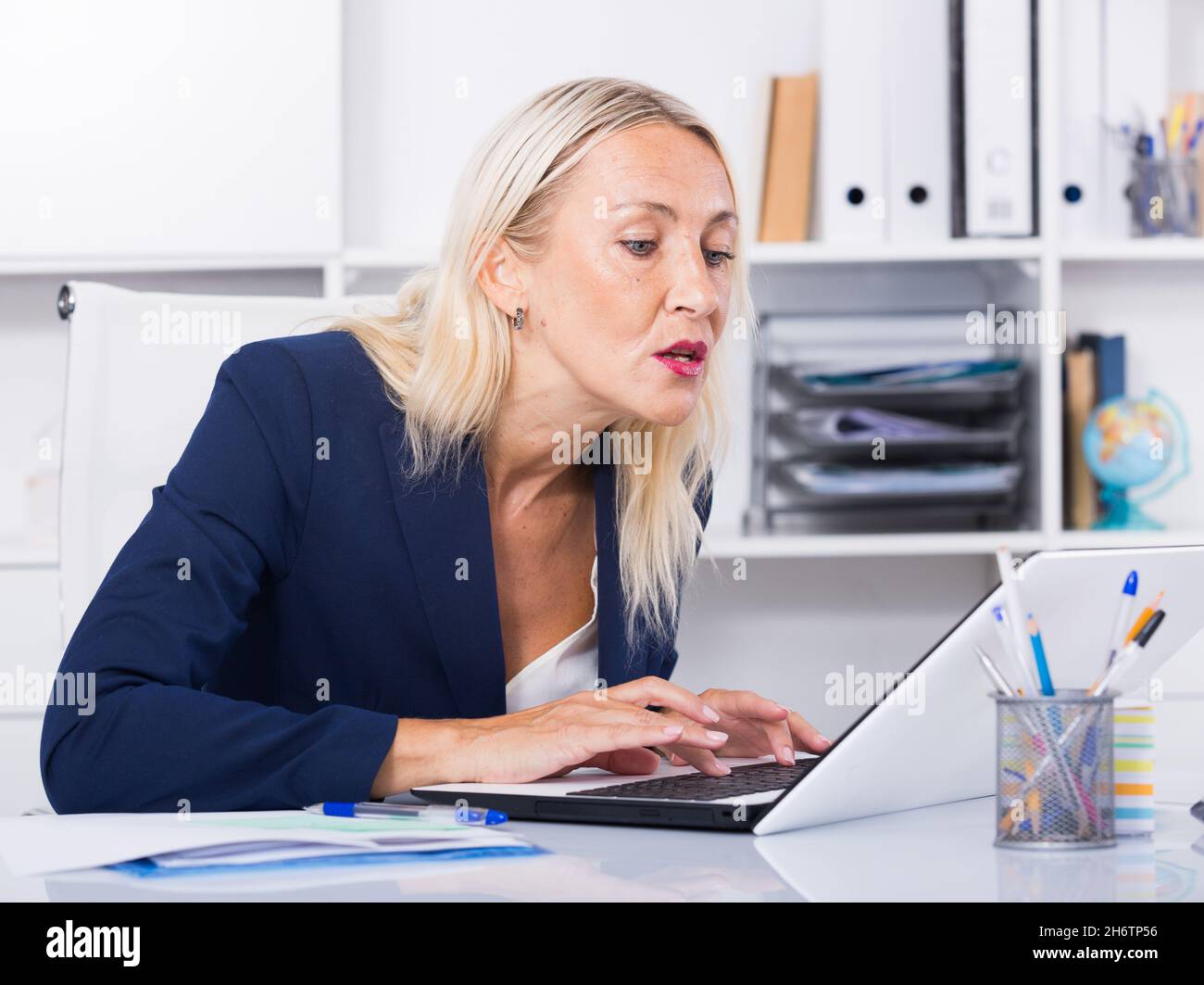 Businesswoman concentrated on work in office Stock Photo - Alamy