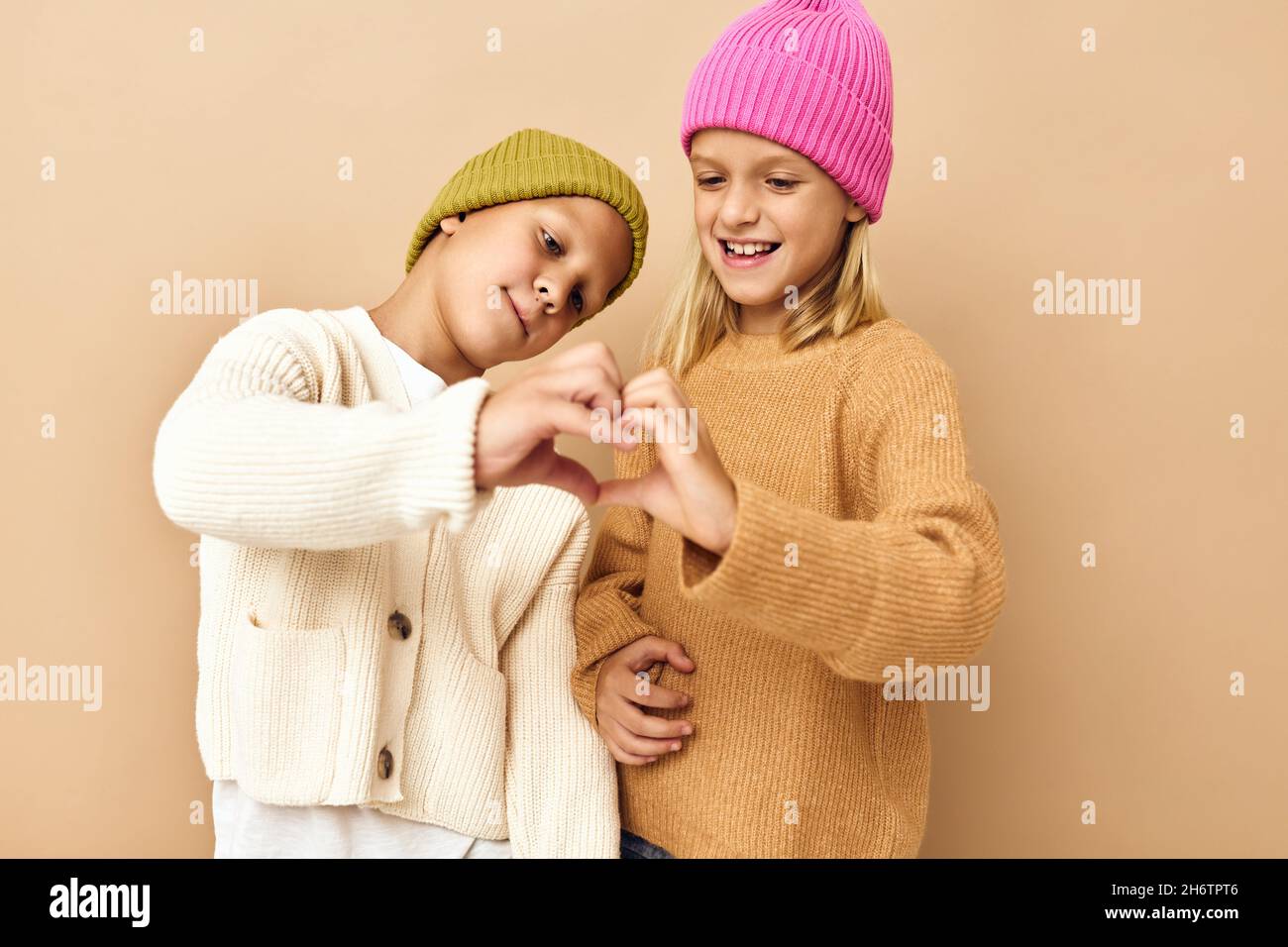 children hug childhood grimace emotions beige background Stock Photo ...