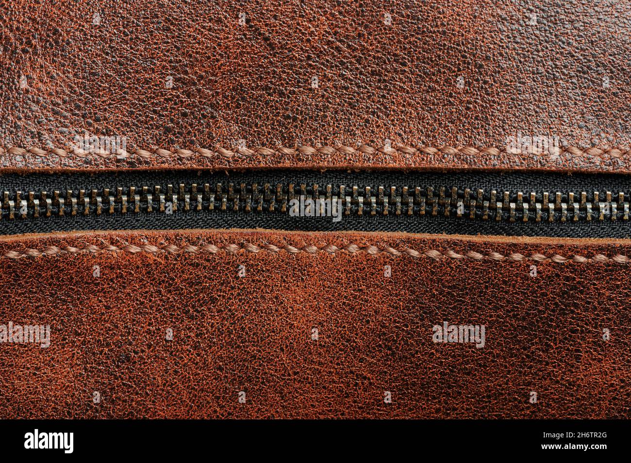 Zip lock on brown leather background macro close up view Stock Photo ...