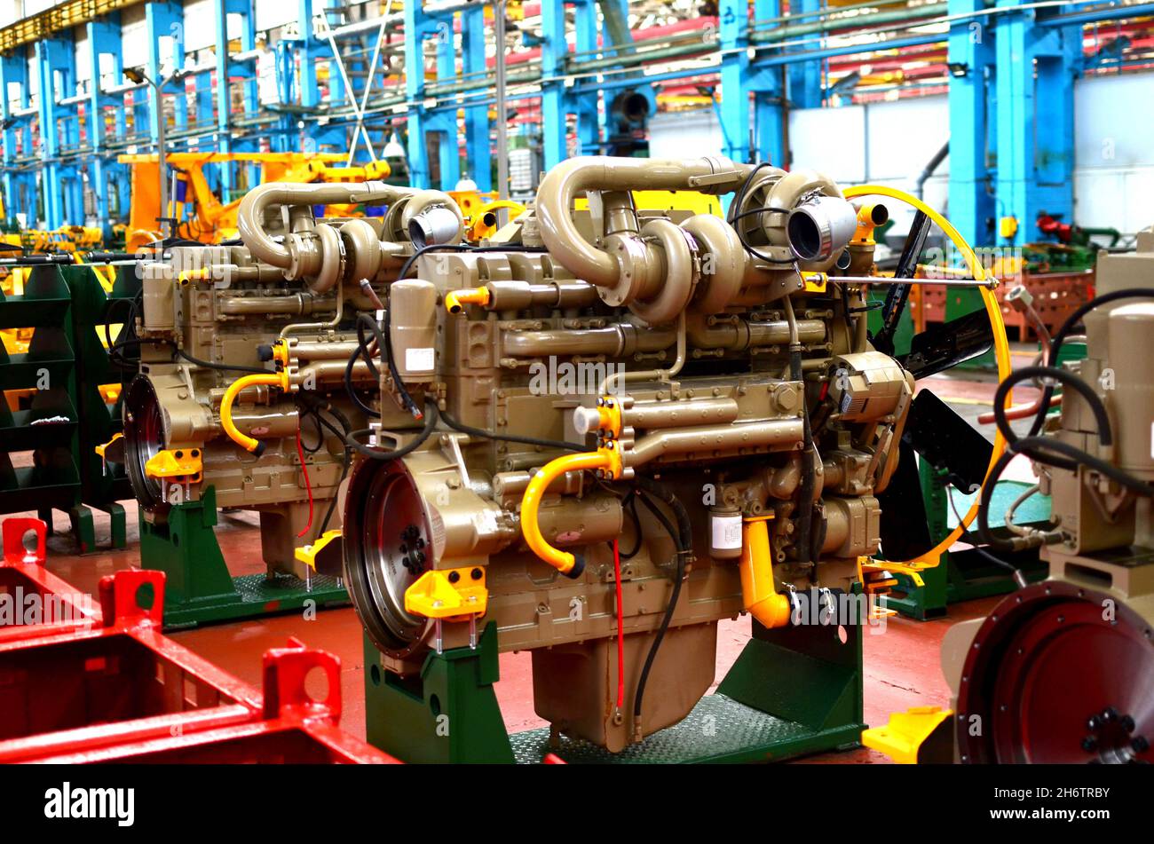 Diesel engines with huge turbines on assembly line in the workshop of ...