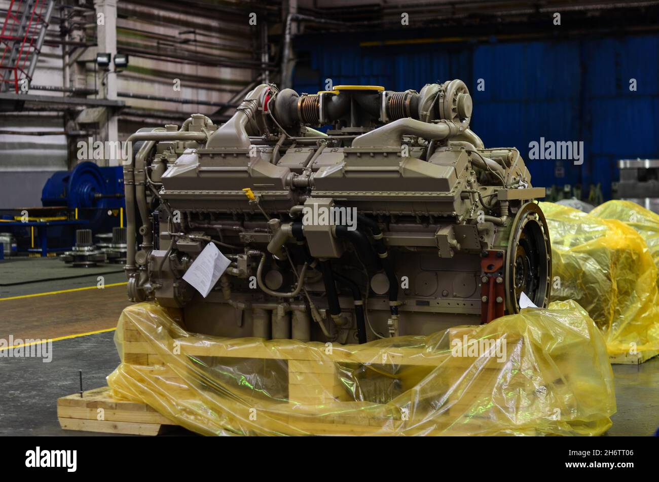 Large diesel engine with a huge turbine in the warehouse of finished ...