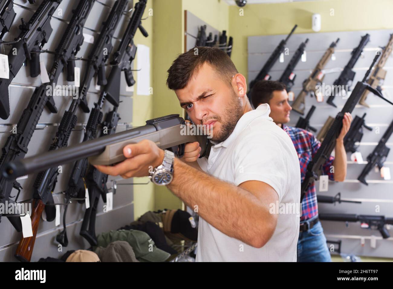 Friends choosing air-powered gun Stock Photo - Alamy